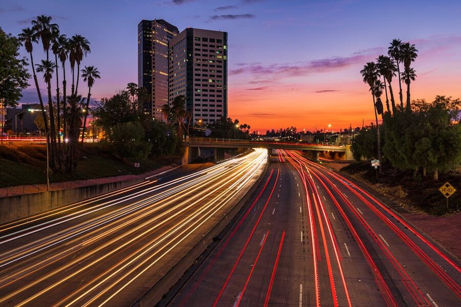 Burbank highway at sunset with palm trees and light trails