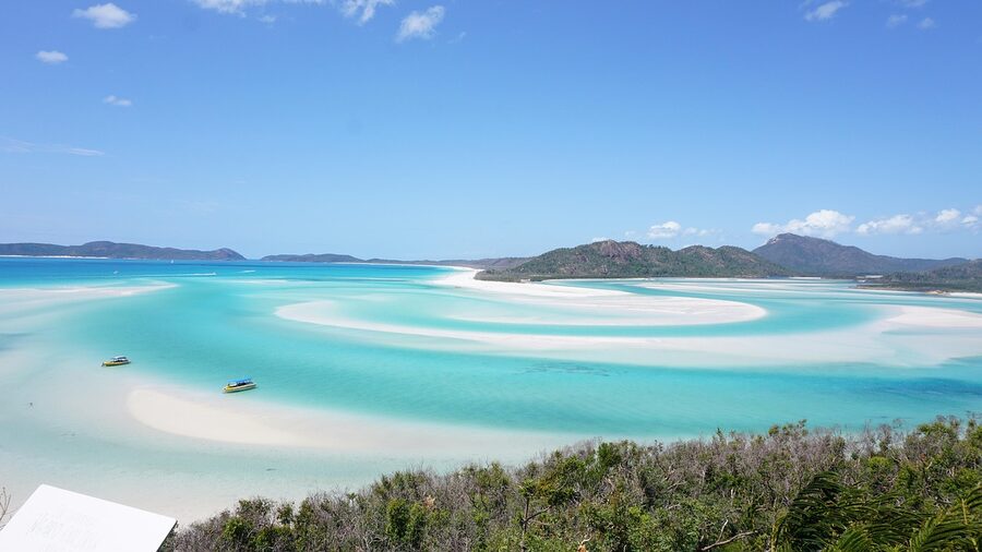 Sailboat anchored off Whitehaven Beach Whitsunday Islands