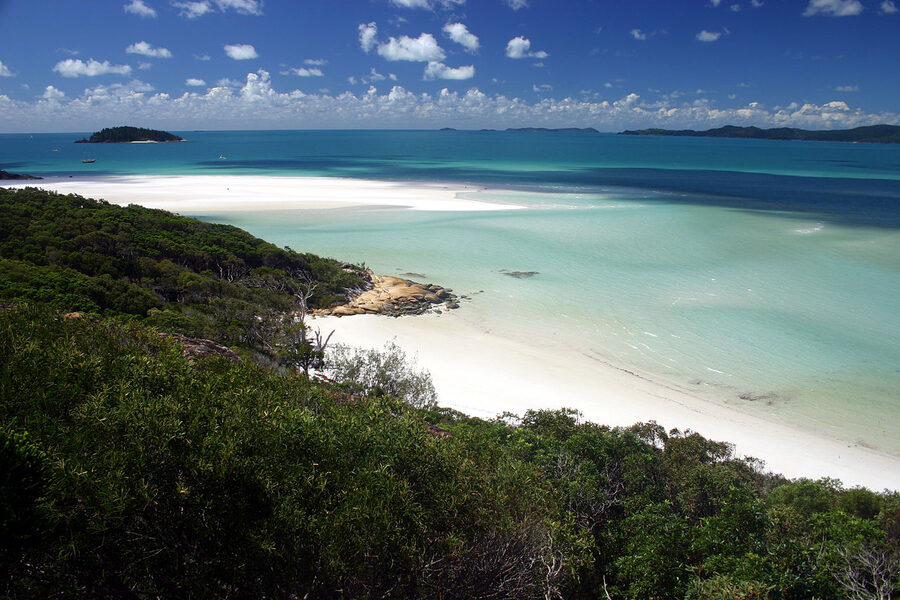 Walking along the Whitehaven Beach shoreline with white sand and turquoise water