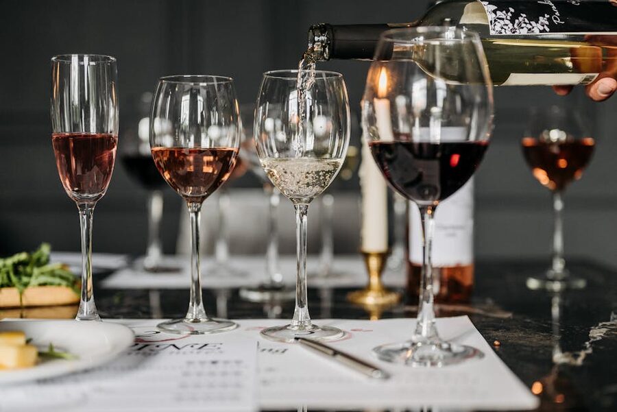 Wine tasting flight with three glasses being poured