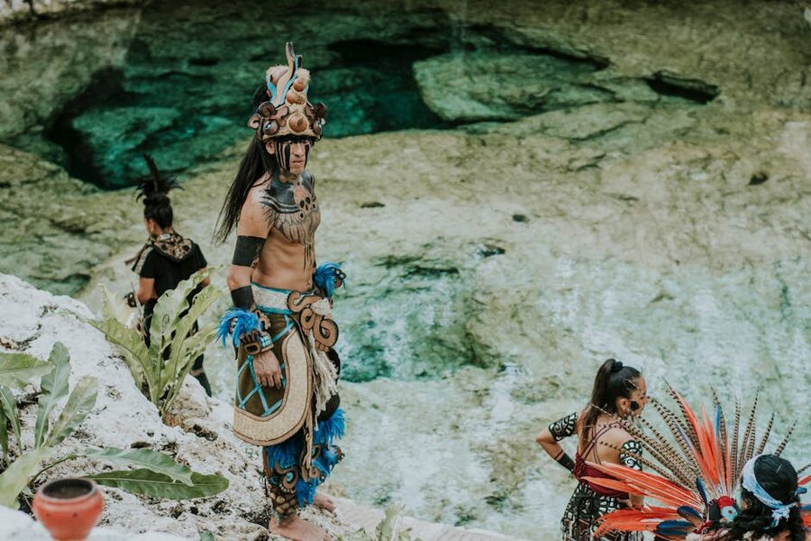 Mayan ceremony performers beside cenote at Xcaret Riviera Maya