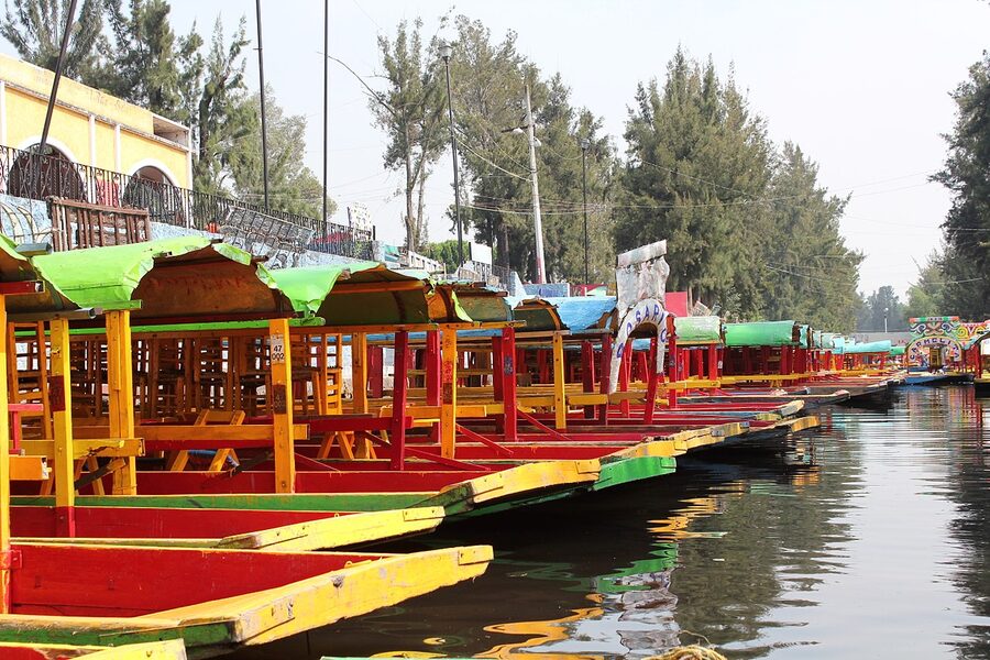 Row of trajinera boats at Xochimilco embarcadero