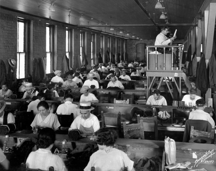 Lector reading to cigar workers at Cuesta-Rey Cigar Company in 1929 historic photograph