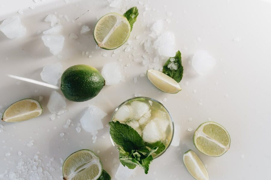 Refreshing mojito cocktail with lime slices and mint top view
