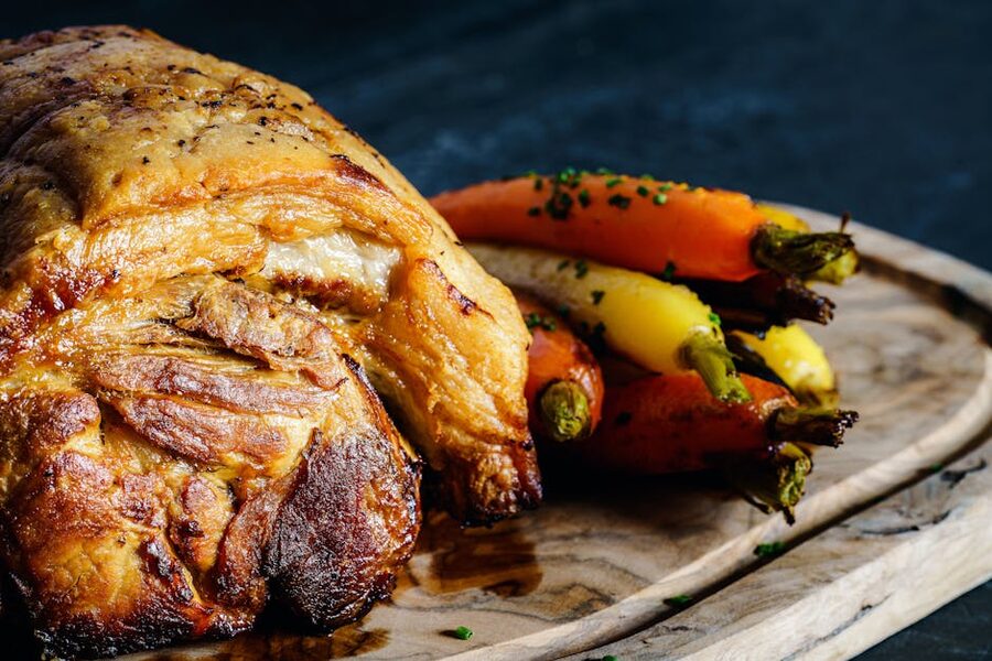 Roast pork with vegetables on a wooden board mojo style