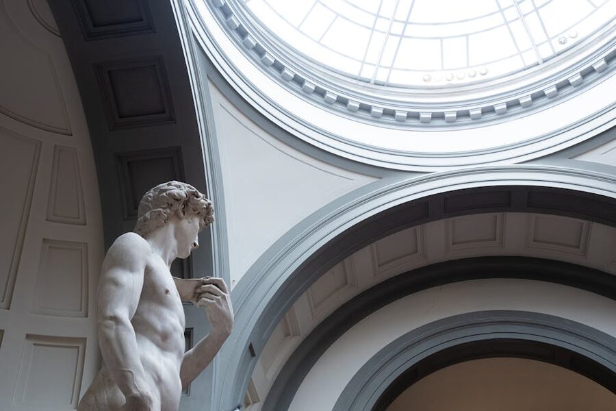 Side view of Michelangelo's David under the Accademia skylight