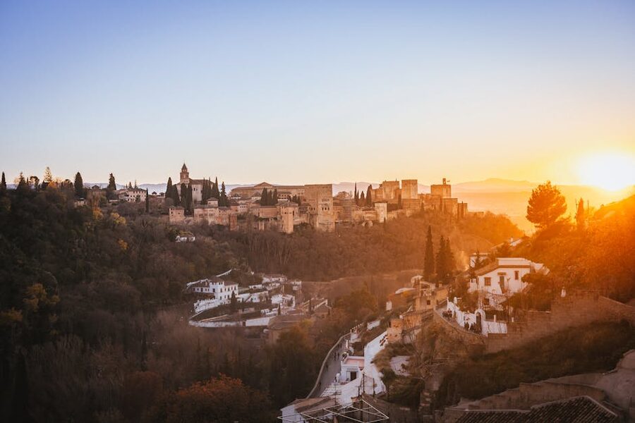Alhambra at sunset seen from Granada with golden light
