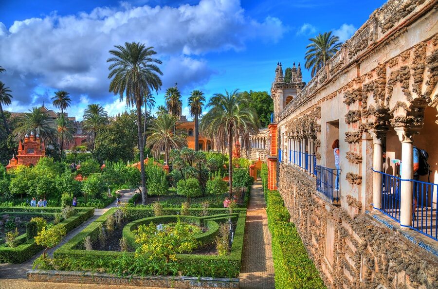 Path through royal gardens of Alcazar Seville in summer