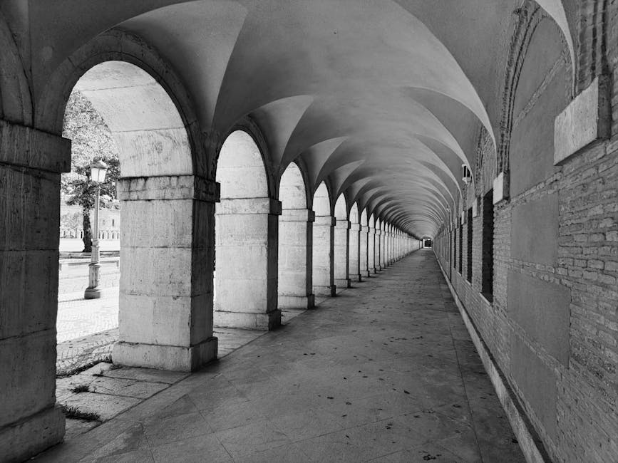 Long colonnade of the Royal Palace of Aranjuez in black and white