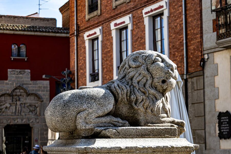 Stone lion sculpture in Avila historic plaza