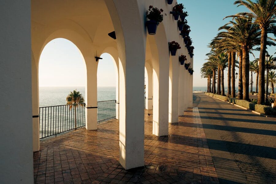 Balcón de Europa archway with palm trees in Nerja, Spain