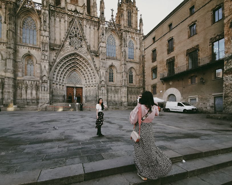 Tourists photographing Barcelona Cathedral Gothic facade