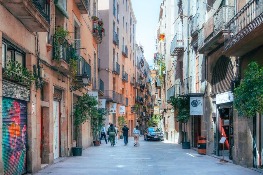 Narrow lane with hanging laundry and stone walls in Barcelona Gothic Quarter