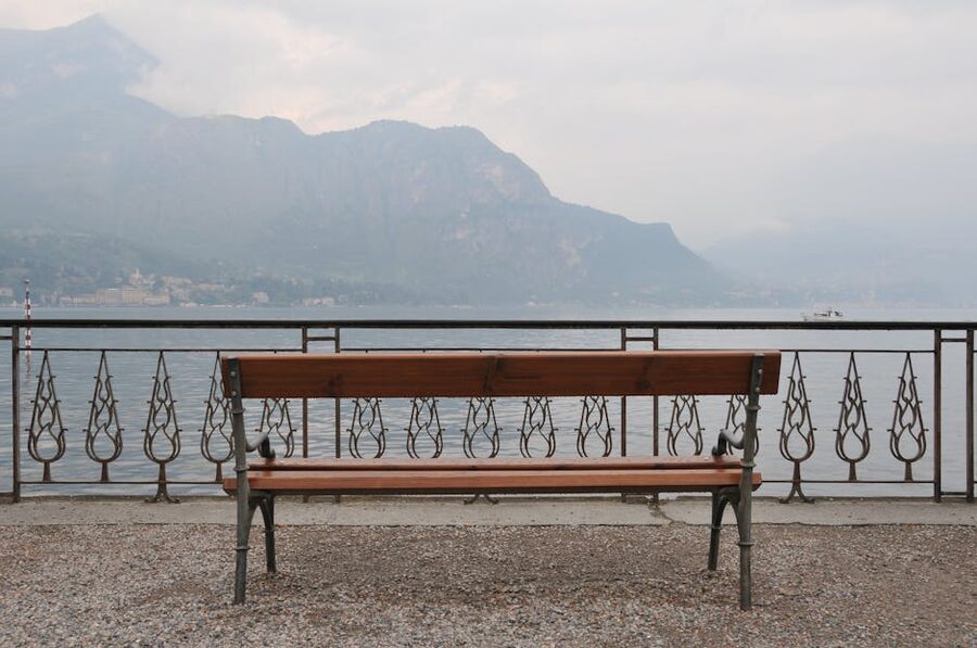 View of Lake Como from a quiet bench in Bellagio with mountains behind