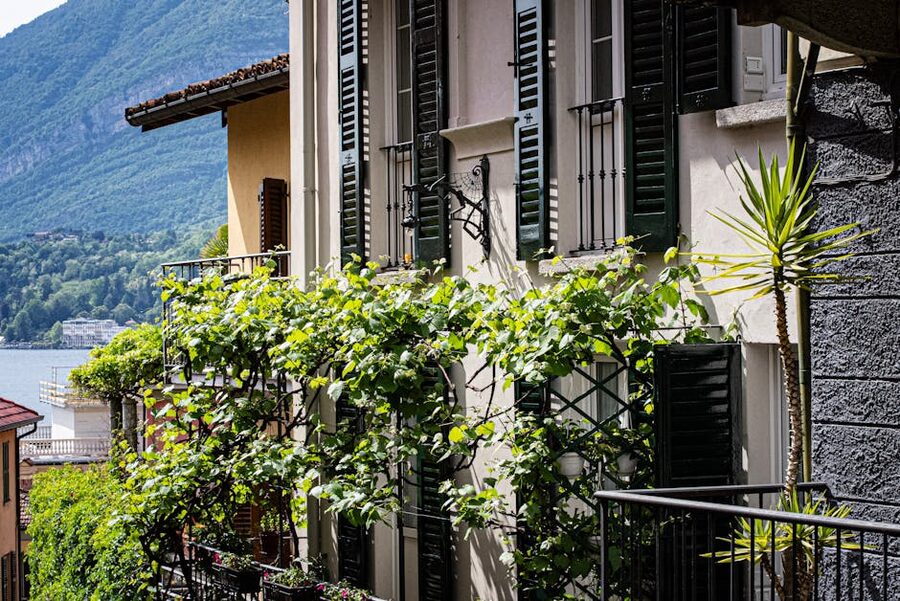 Windows with shutters and greenery overlooking Lake Como in Bellagio