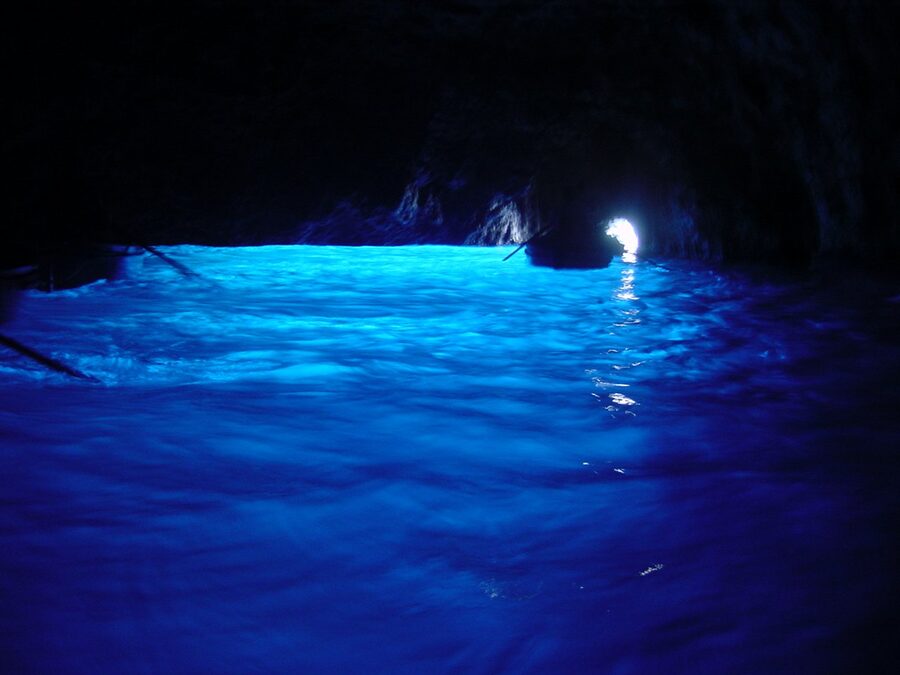 Inside the Blue Grotto on Capri showing the bright blue water