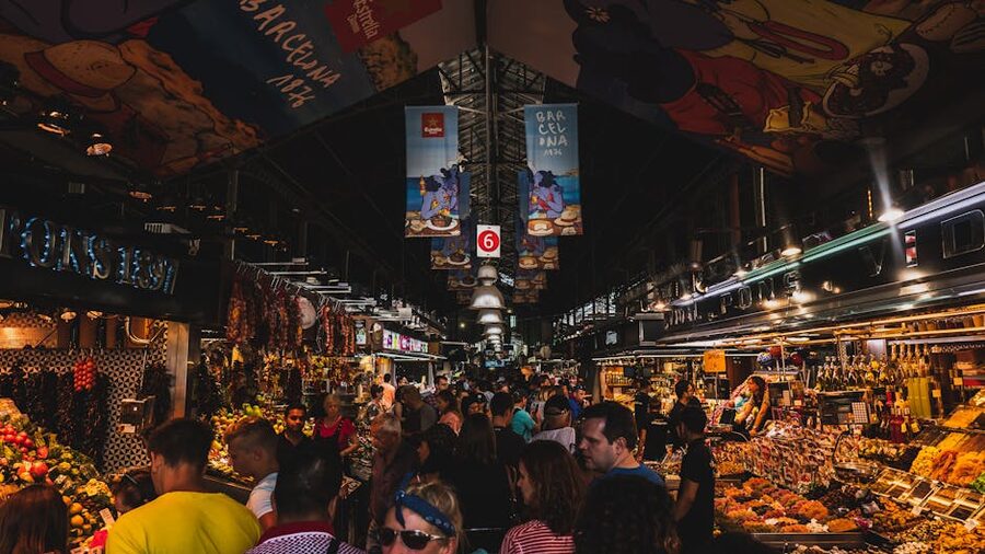 Crowded market aisle inside La Boqueria with shoppers and stalls