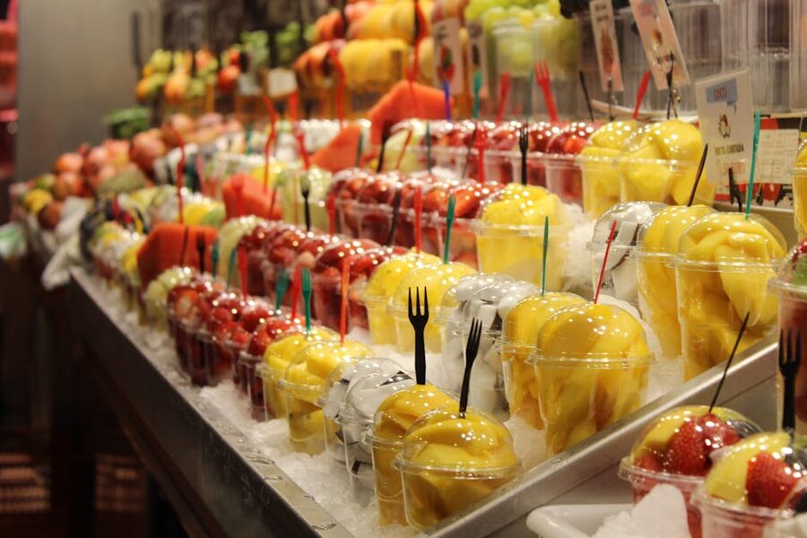 Fresh fruit cups displayed at La Boqueria entrance Barcelona