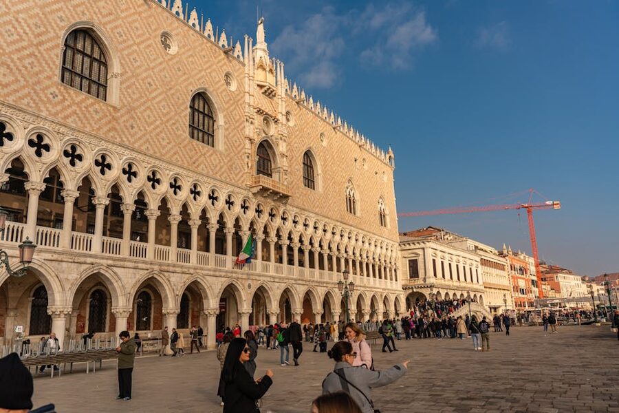 Tourists at the Doge's Palace exterior facade Venice