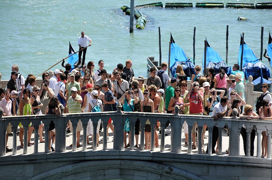 Tourists on the Ponte della Paglia photographing Bridge of Sighs Venice