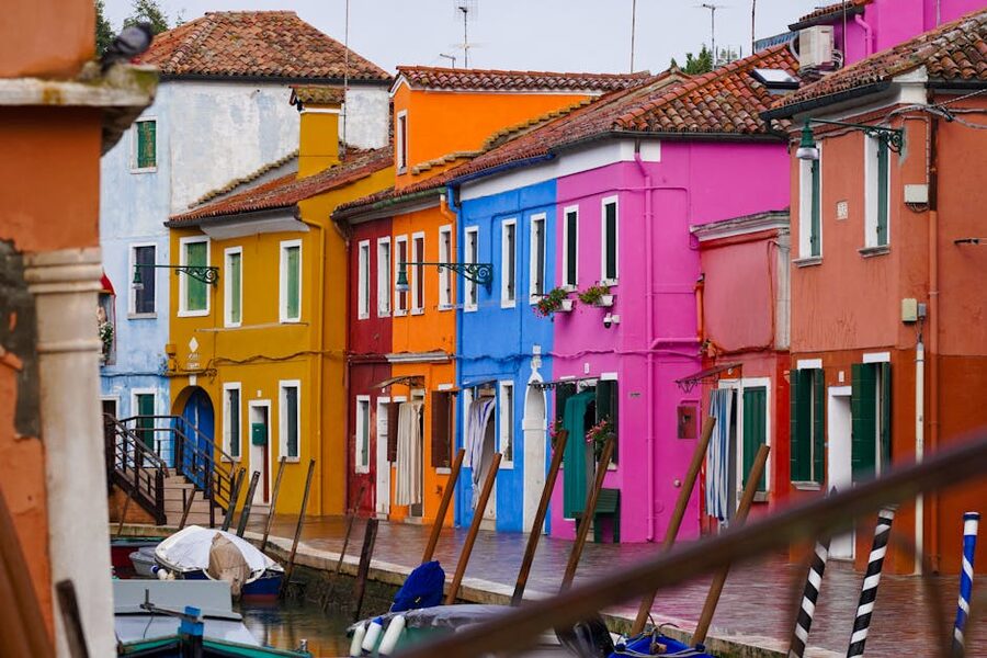 Burano canal lined with colourful painted houses, Venice lagoon Italy