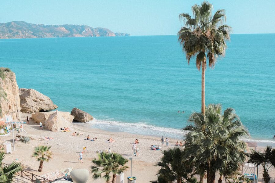 Burriana Beach in Nerja with palm trees and clear water