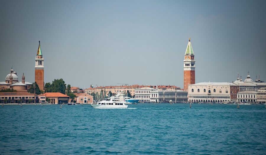 St Mark's Campanile seen from the canal with a blue boat