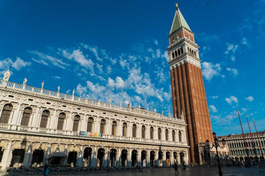 St Mark's Campanile and Doge's Palace under blue sky in Venice