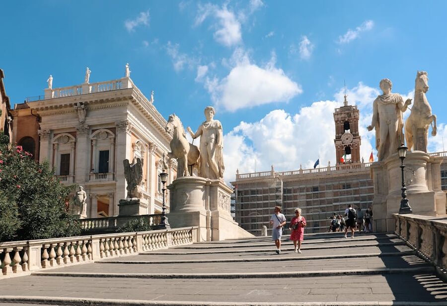 Historical sculptures at Capitoline Hill in Rome with tourists