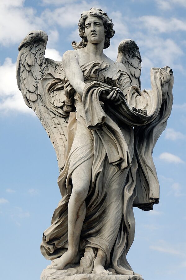 Close-up of an angel statue holding garment and dice on Ponte Sant'Angelo Rome