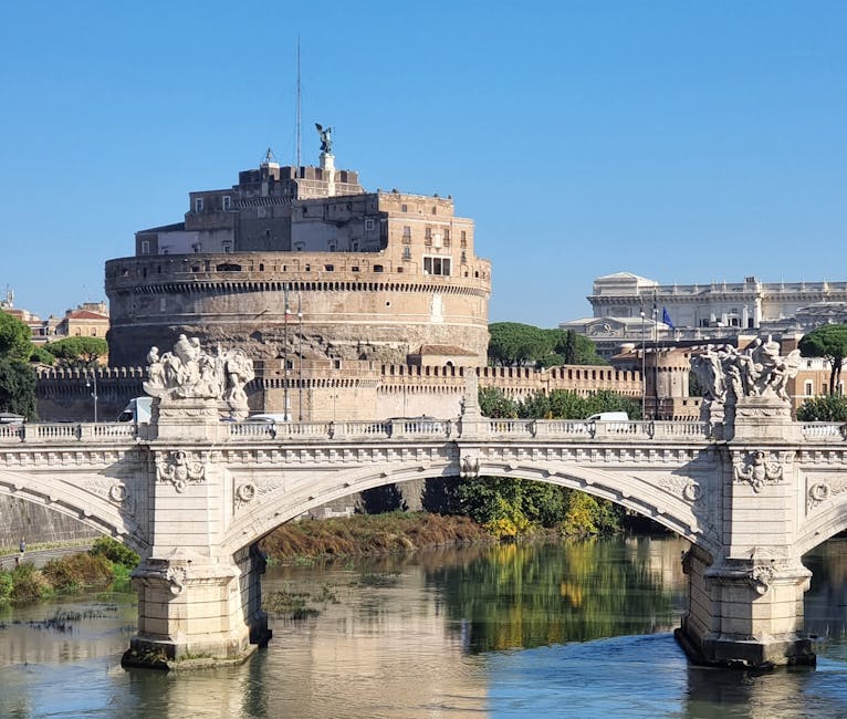 Daylight view of Castel Sant'Angelo with Ponte Sant'Angelo and visitors walking the bridge