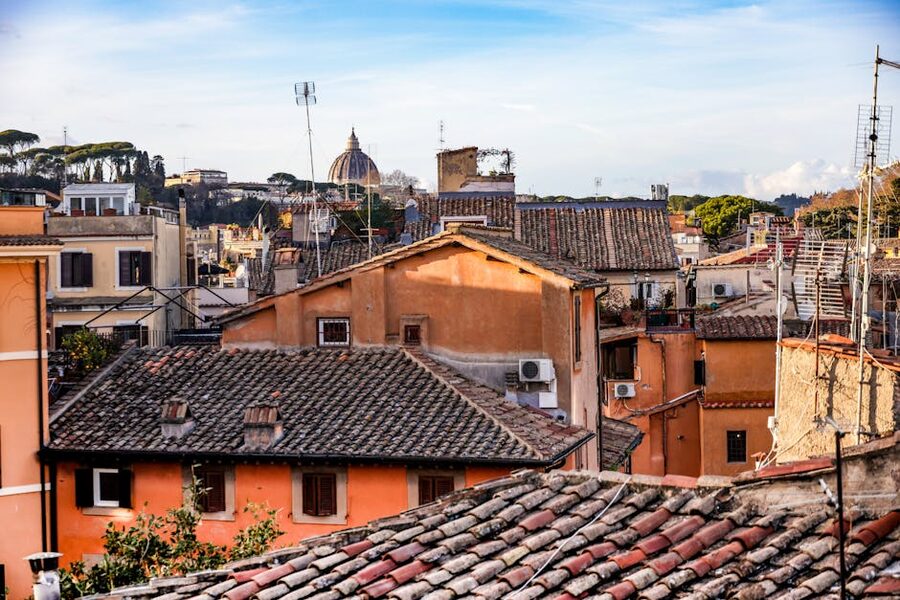 View of Rome rooftops with St Peter's Basilica dome in the distance