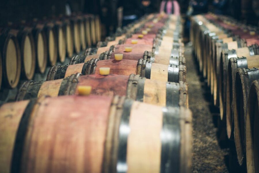 Wooden wine barrels aging in a Tuscan cellar
