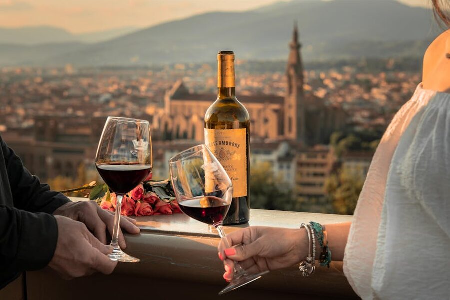 Couple toasting wine glasses with Florence skyline behind