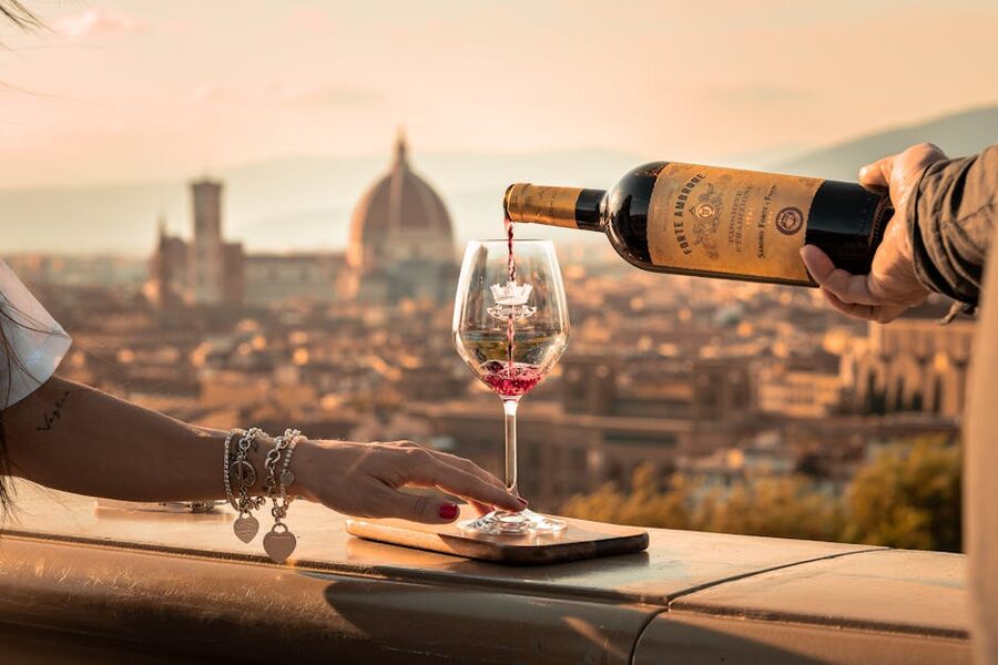 Pouring wine into a glass with the Florence Duomo skyline