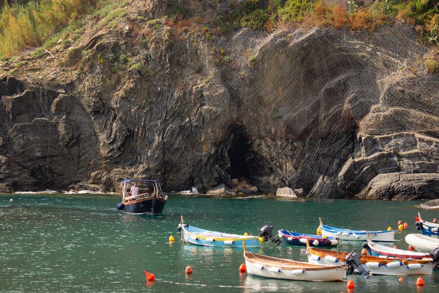 Small boats off Vernazza rocky coastline