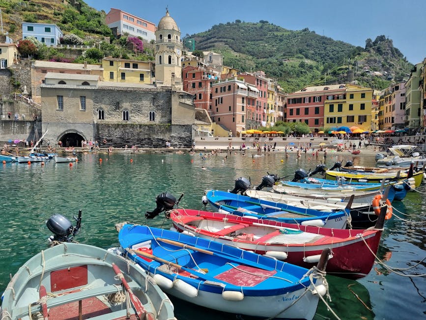 Vernazza summer harbor with historic boats and architecture