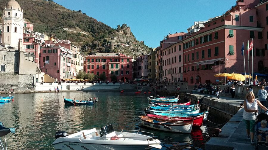 Vernazza marina seen from the breakwater with tour boats and water taxi