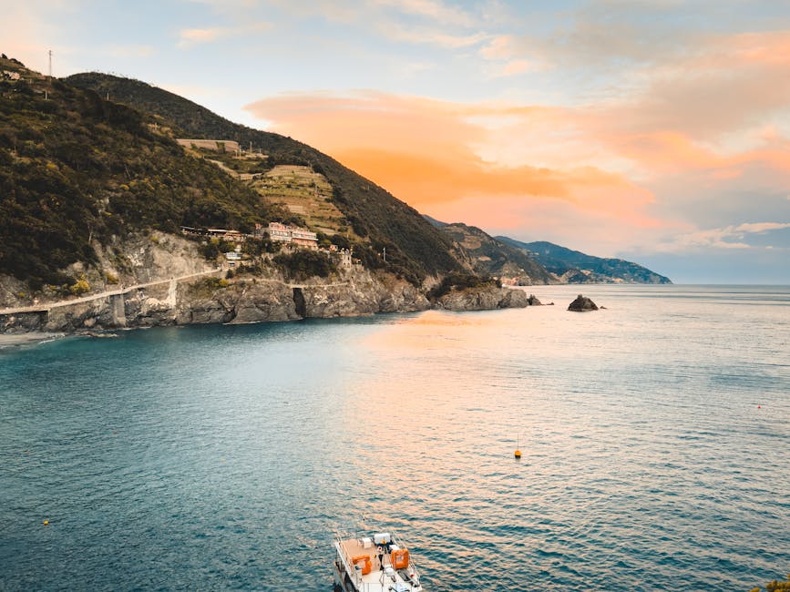 Aerial yacht near Liguria cliffs at sunset