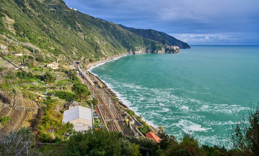 Aerial view of Cinque Terre coastline with railway line