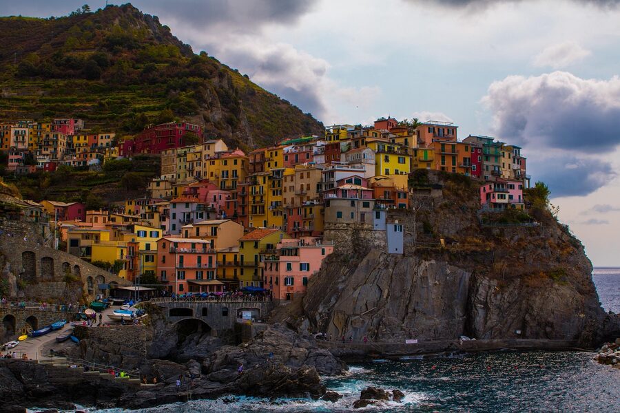 Hiker walking through terraced vineyards above Manarola