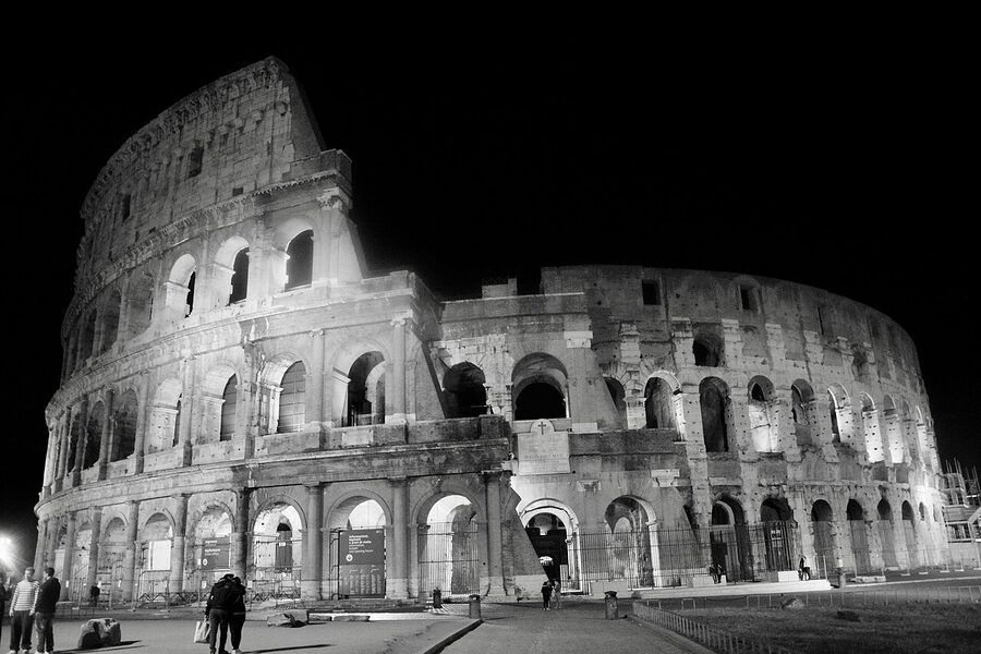 Colosseum exterior at night with arches glowing