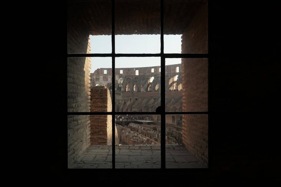 Colosseum interior framed through an ancient window opening