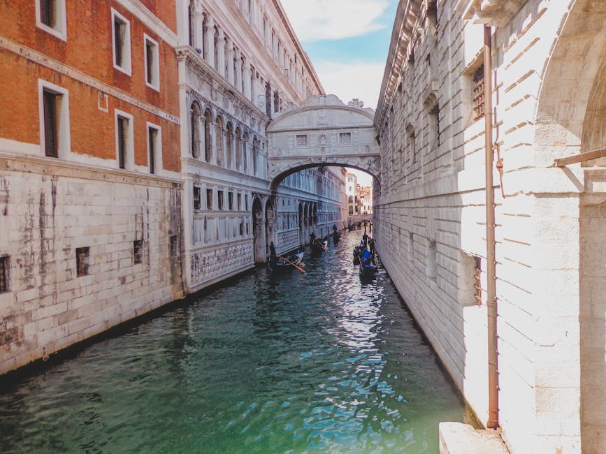 The Bridge of Sighs in Venice with gondolas underneath