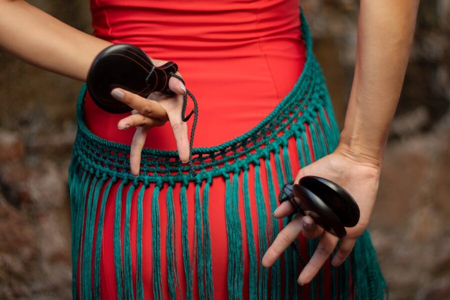 Flamenco dancer's hands holding castanets in close detail