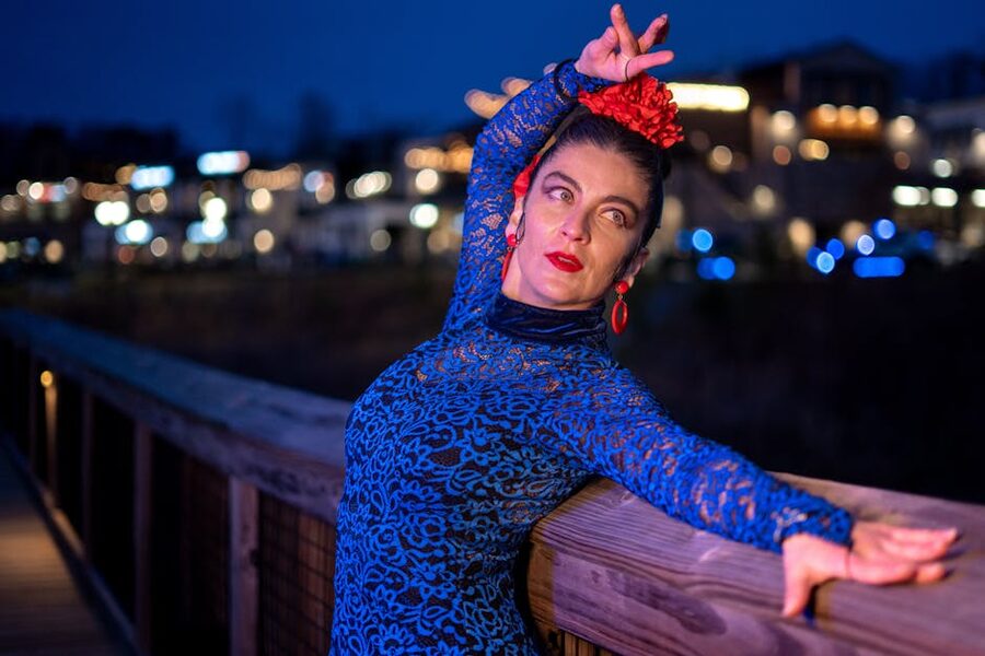 Flamenco dancer in a colourful traditional dress on a Madrid street at night