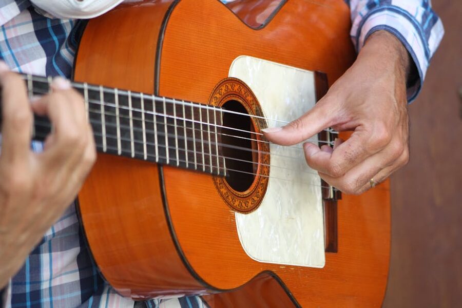 Flamenco guitarist's hands on a Spanish guitar in a Madrid tablao