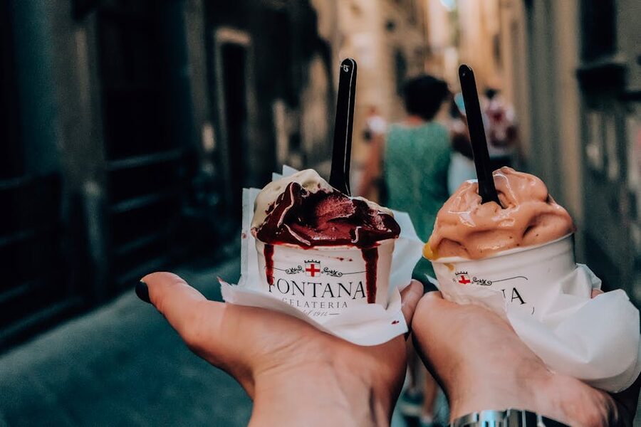 Tourists eating gelato on a Florence street