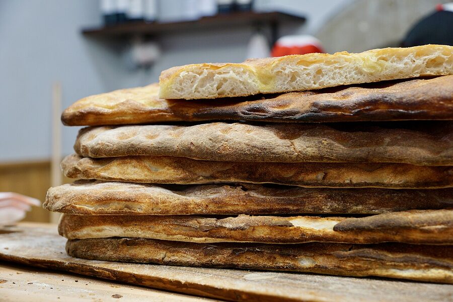 Schiacciata alla fiorentina loaves stacked in a Florence bakery