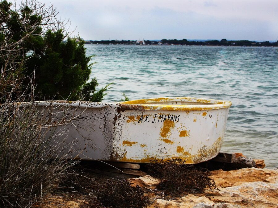 Formentera beach with traditional fishermans boat